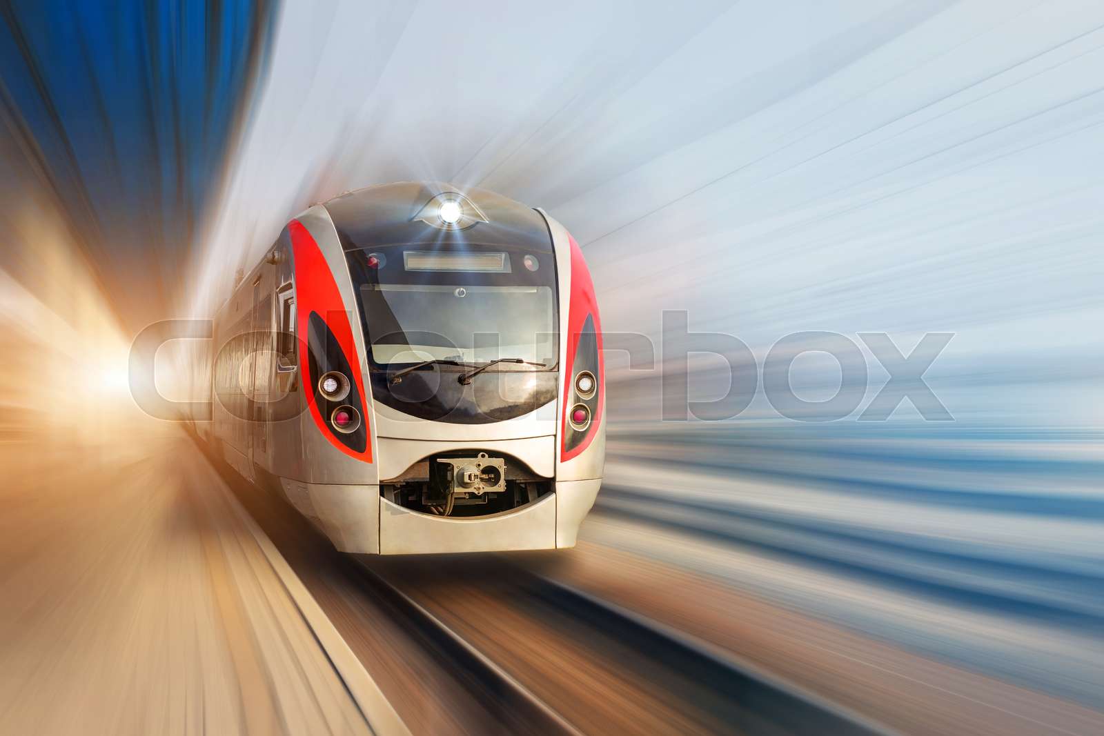 Modern passenger high-speed electric train moving fast along terminal ...