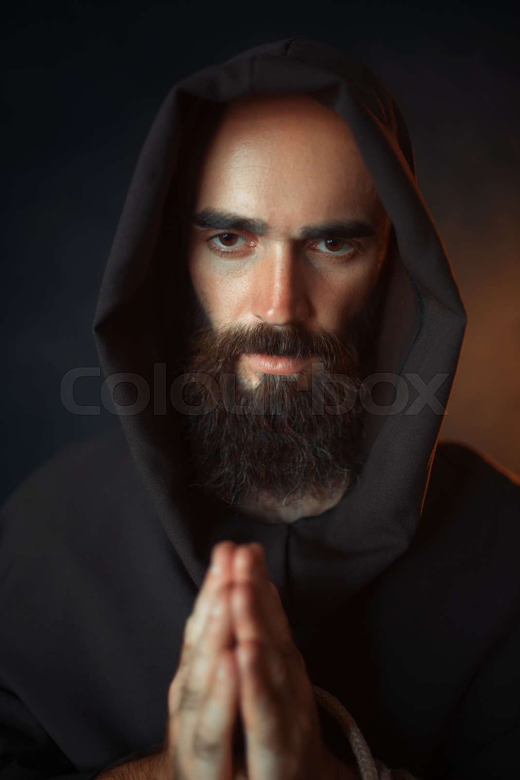 Medieval monk praying with closed eyes | Stock image | Colourbox