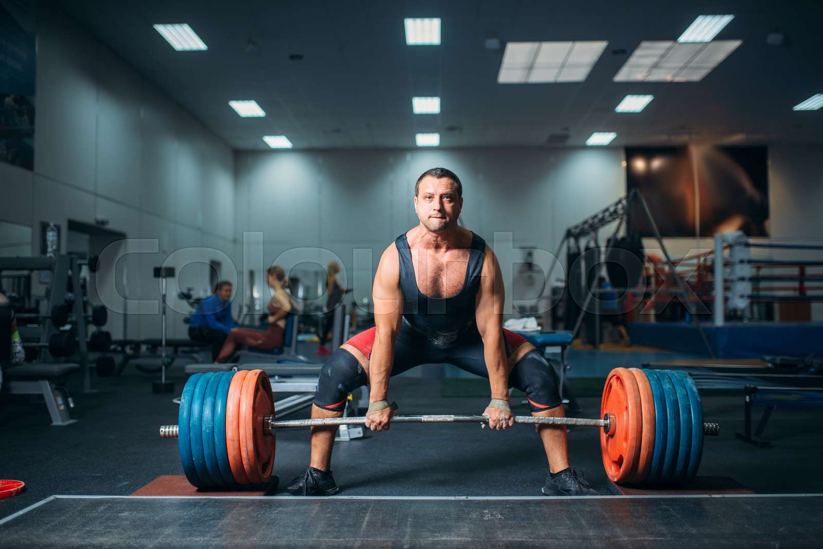 Male weightlifter prepares to pull heavy barbell | Stock image | Colourbox