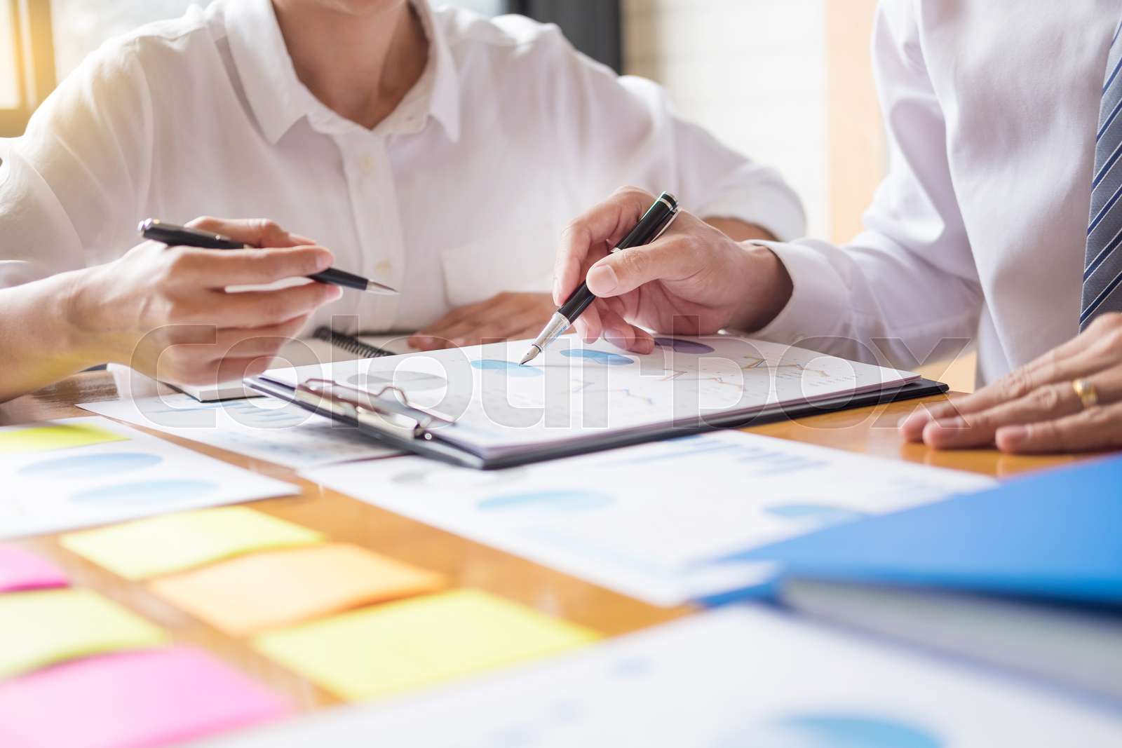 Business team data analyzing income charts document during discussion ...