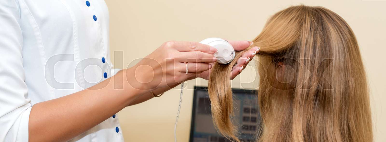Hair doctor checking hair. Doctor examine patient female hair a special ...
