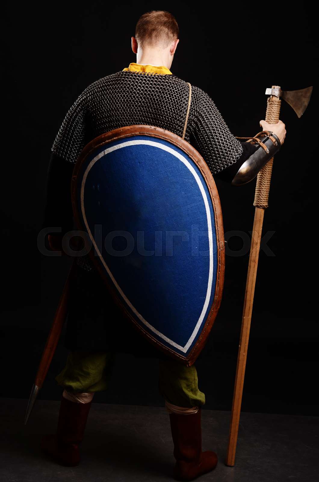 Warrior Stand his back to the camera with a shield on his back a ...