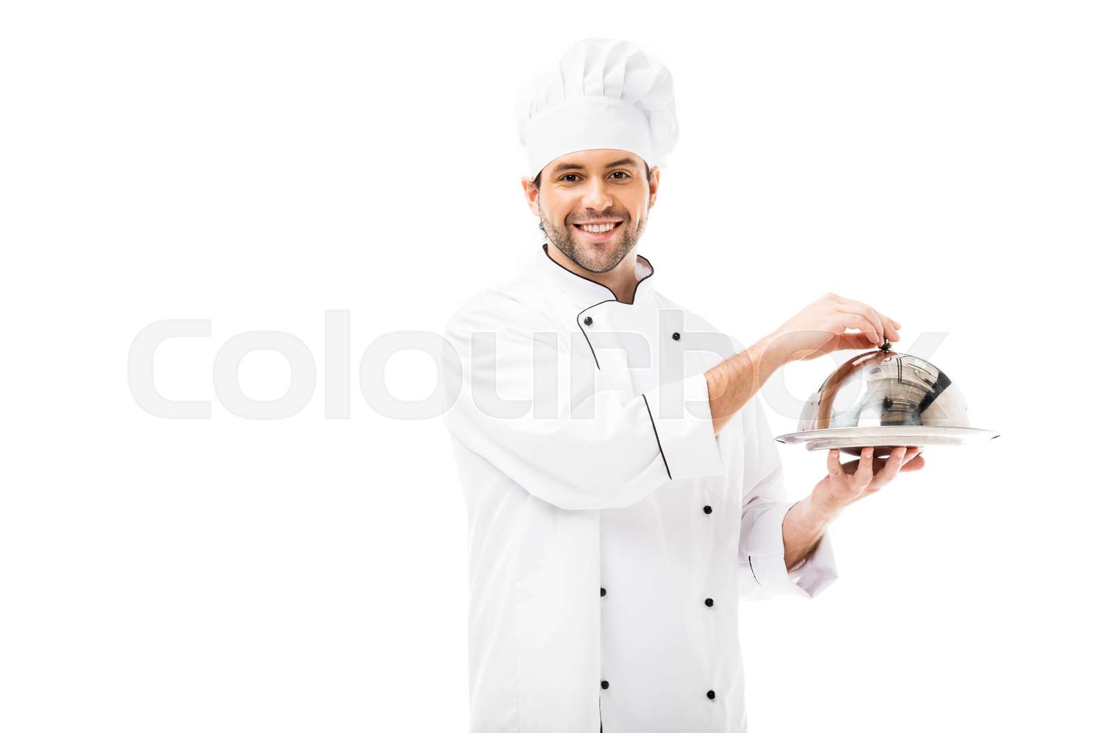 handsome young chef holding serving dish with dome and looking at ...