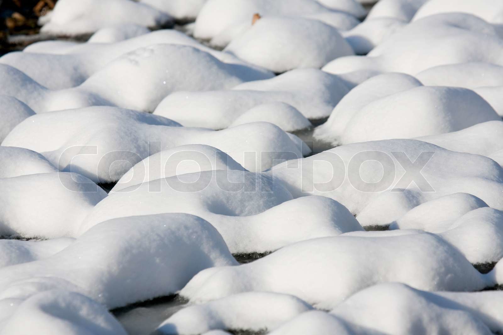 Bumpy lawn covered with snow | Stock image | Colourbox