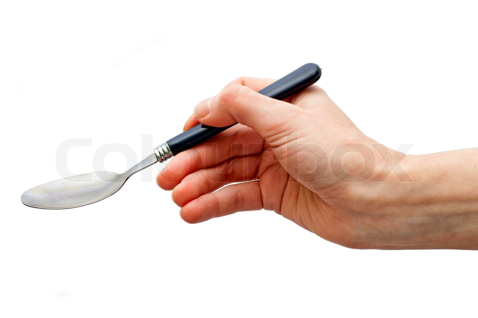 Hand with spoon | Stock image | Colourbox