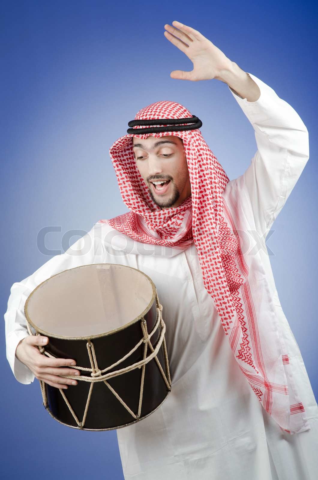 Arab playing drum in studio shooting | Stock image | Colourbox