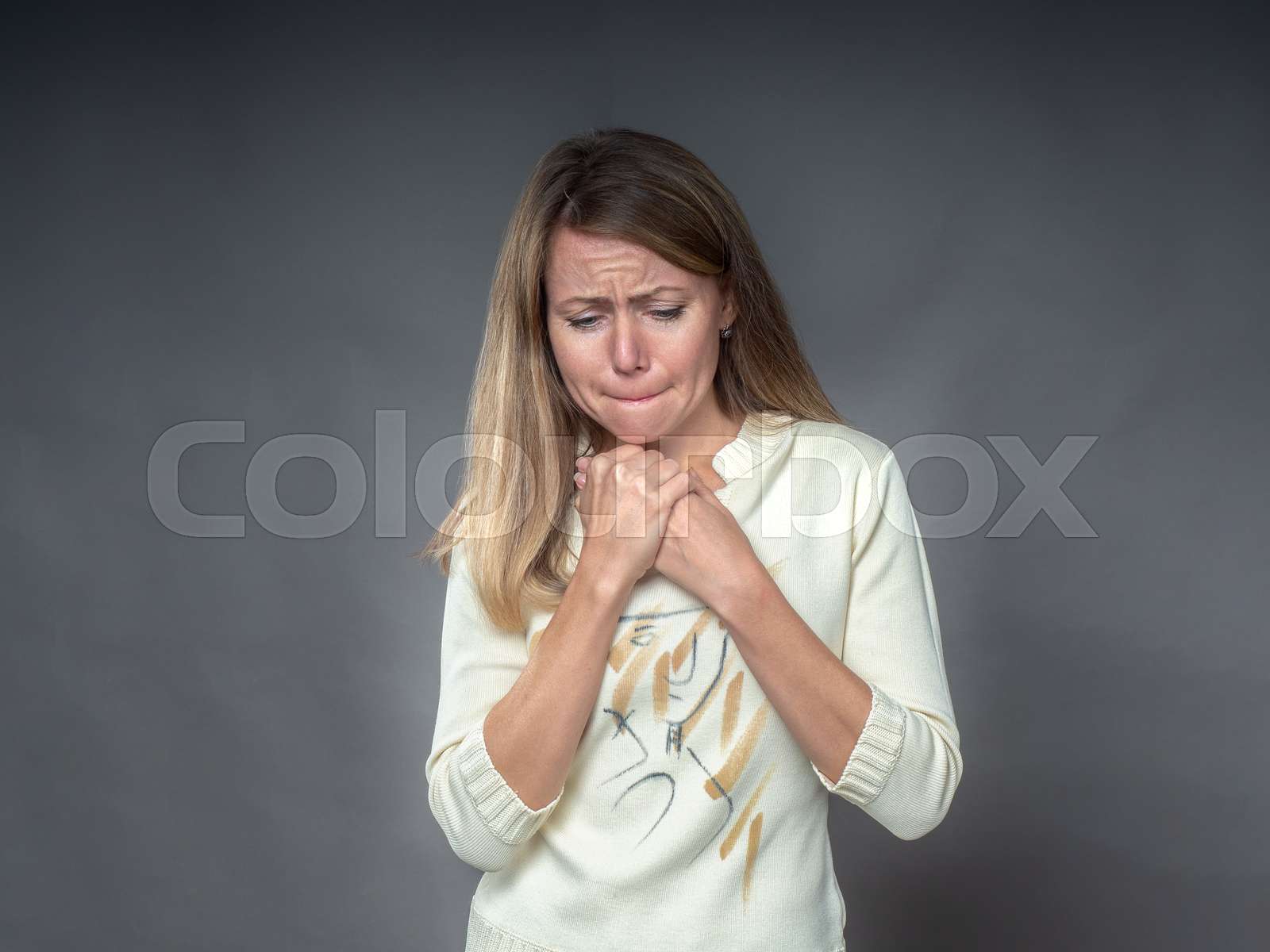 Woman with hands on his chest sorrowfully with regret and sorrow ...