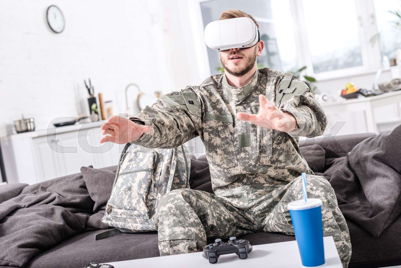 army soldier touching air during vr experience on couch | Stock image ...