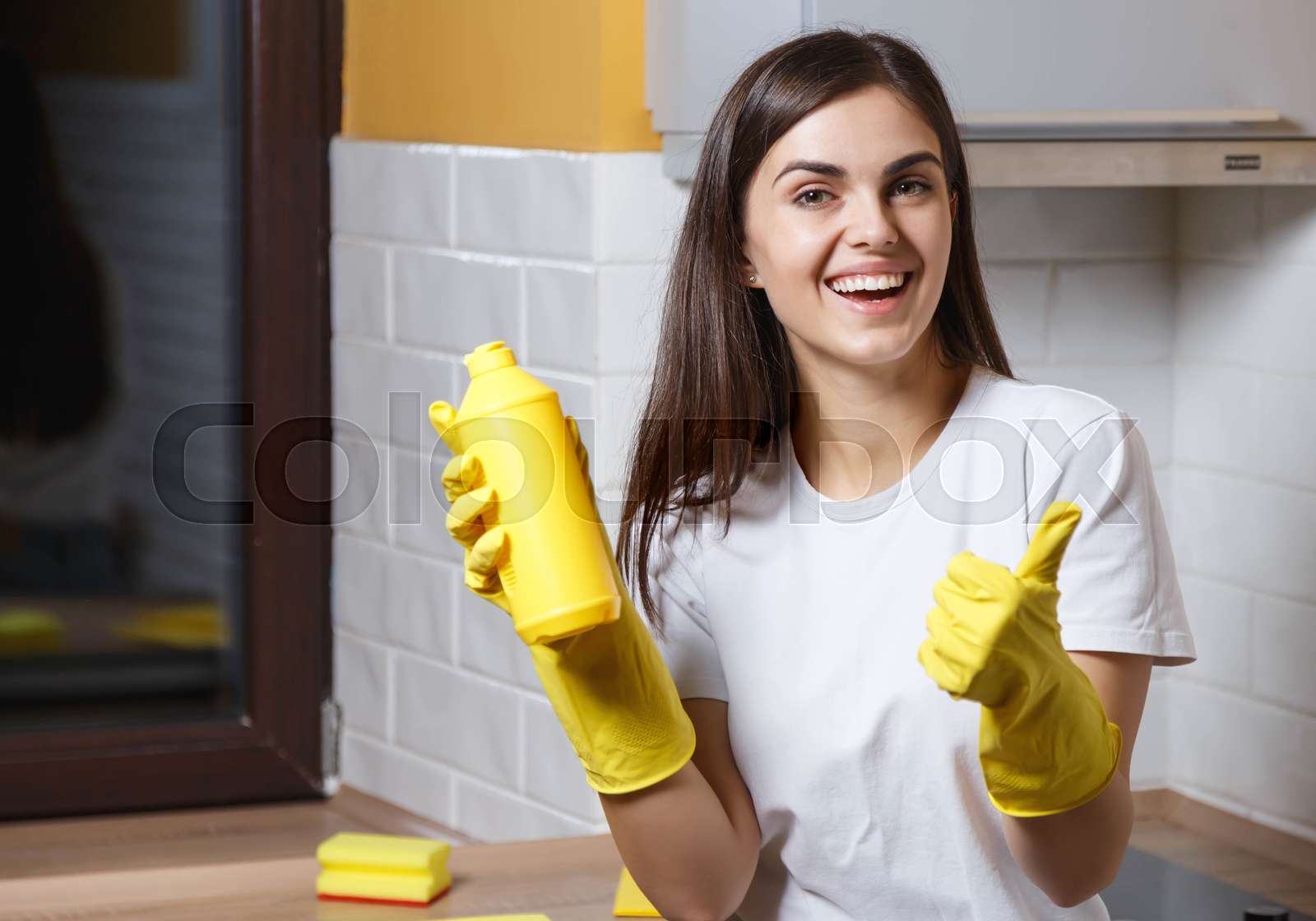 Happy Girl Cleaning A Kitchen | Stock image | Colourbox