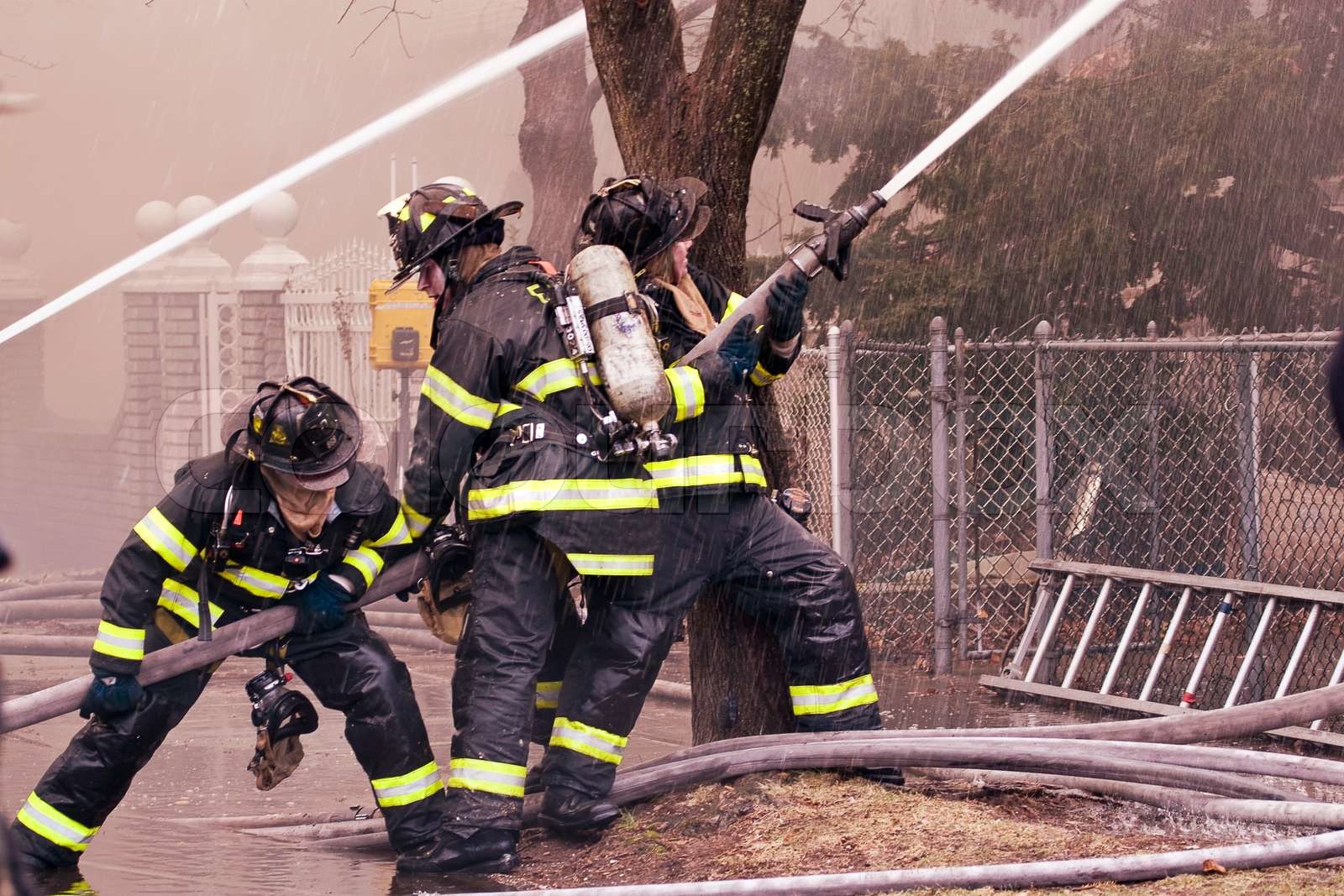 Firemen at work putting out a house fire | Stock image | Colourbox