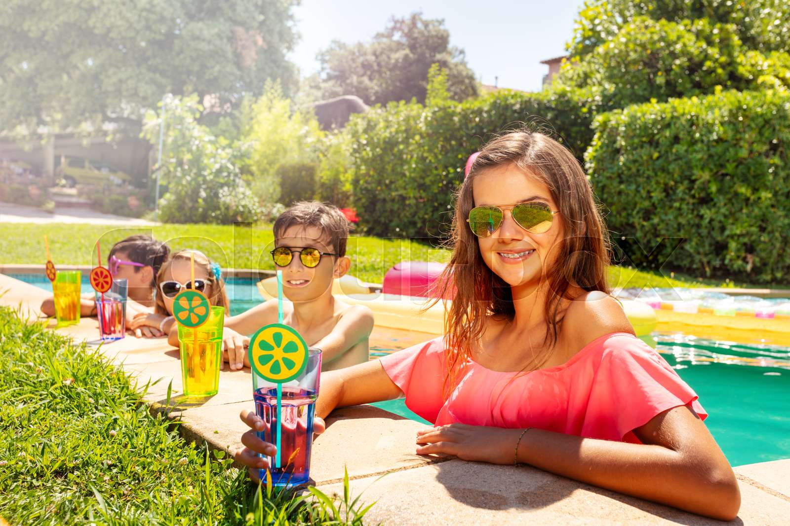 Girl relaxing in swimming pool with friends | Stock image | Colourbox
