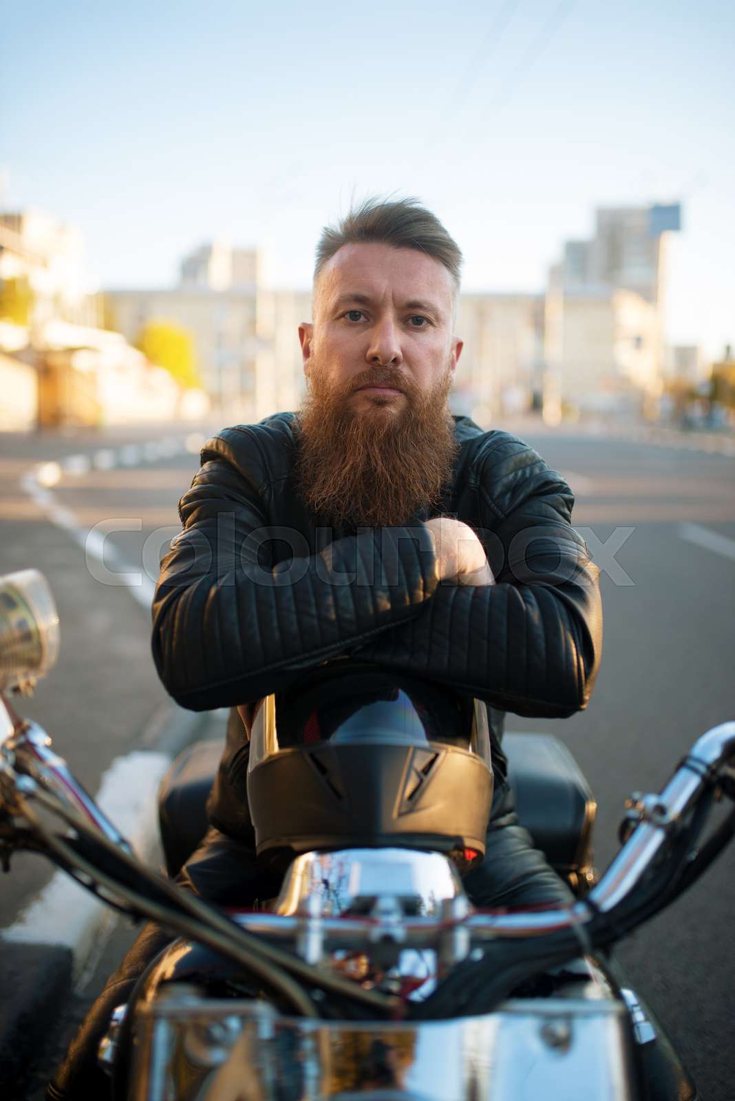 Bearded biker on classical chopper, front view | Stock image | Colourbox
