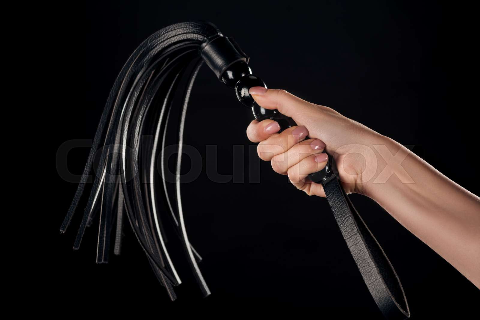 partial view of female hand holding leather flogging whip isolated on ...