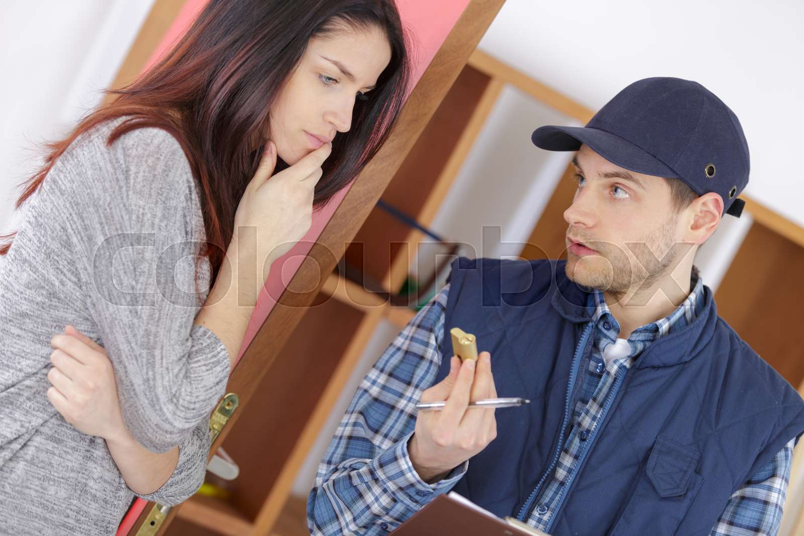 technician talking to female client | Stock image | Colourbox