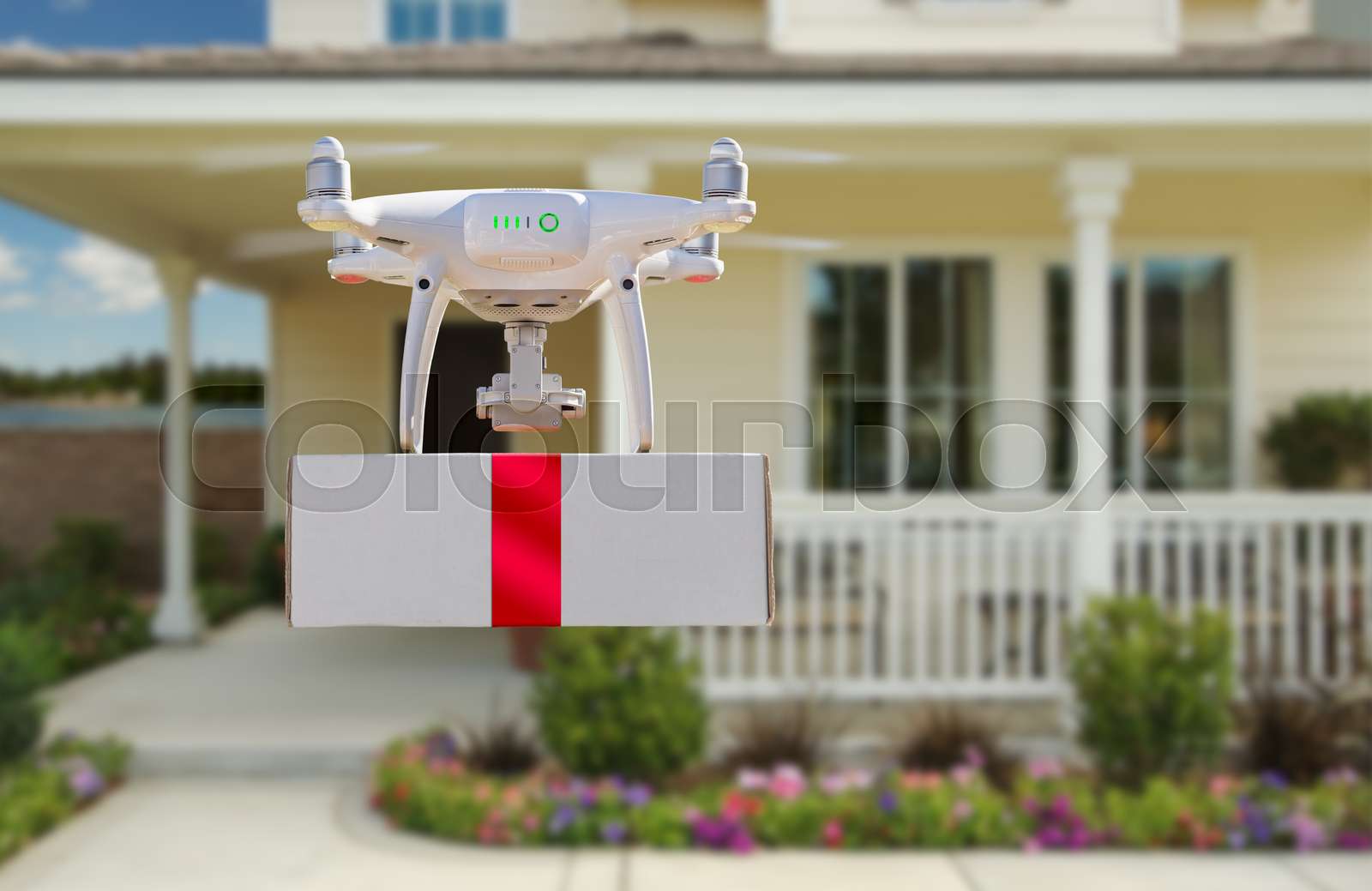 Unmanned Aircraft System (UAV) Quadcopter Drone Delivering Box With Red ...