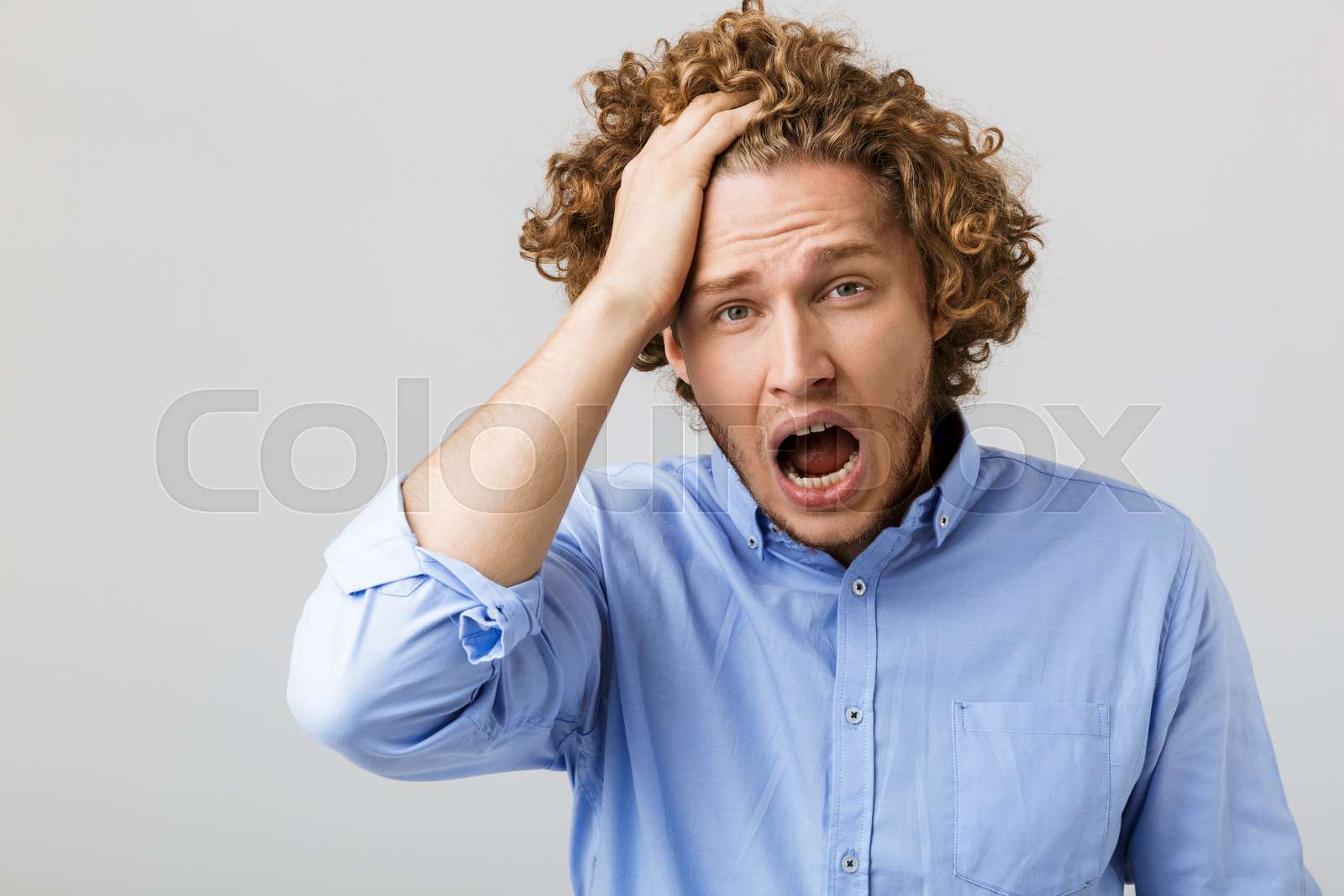 Portrait of a shocked young man wearing shirt | Stock image | Colourbox