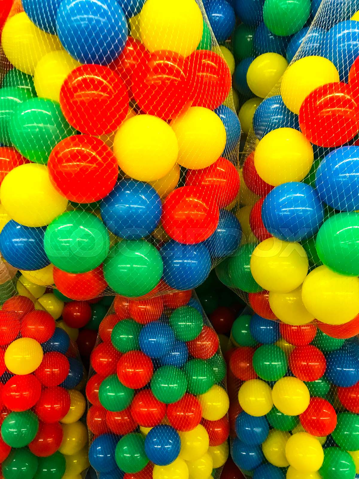Plastic colored balls in grid | Stock image | Colourbox