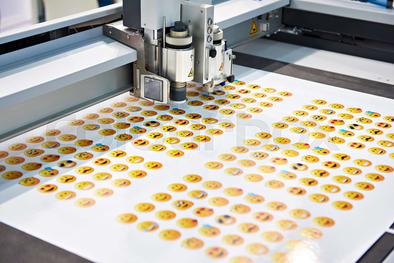 Digital cutting plotter and yellow smileys | Stock image | Colourbox