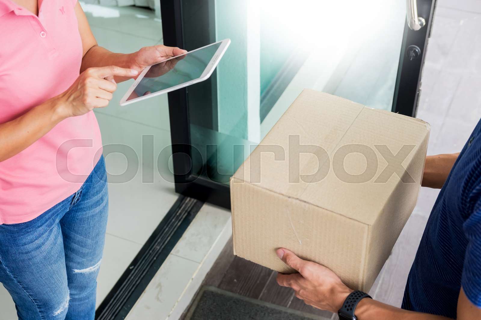 woman courier holding a parcel Shipping Mail appending signature ...