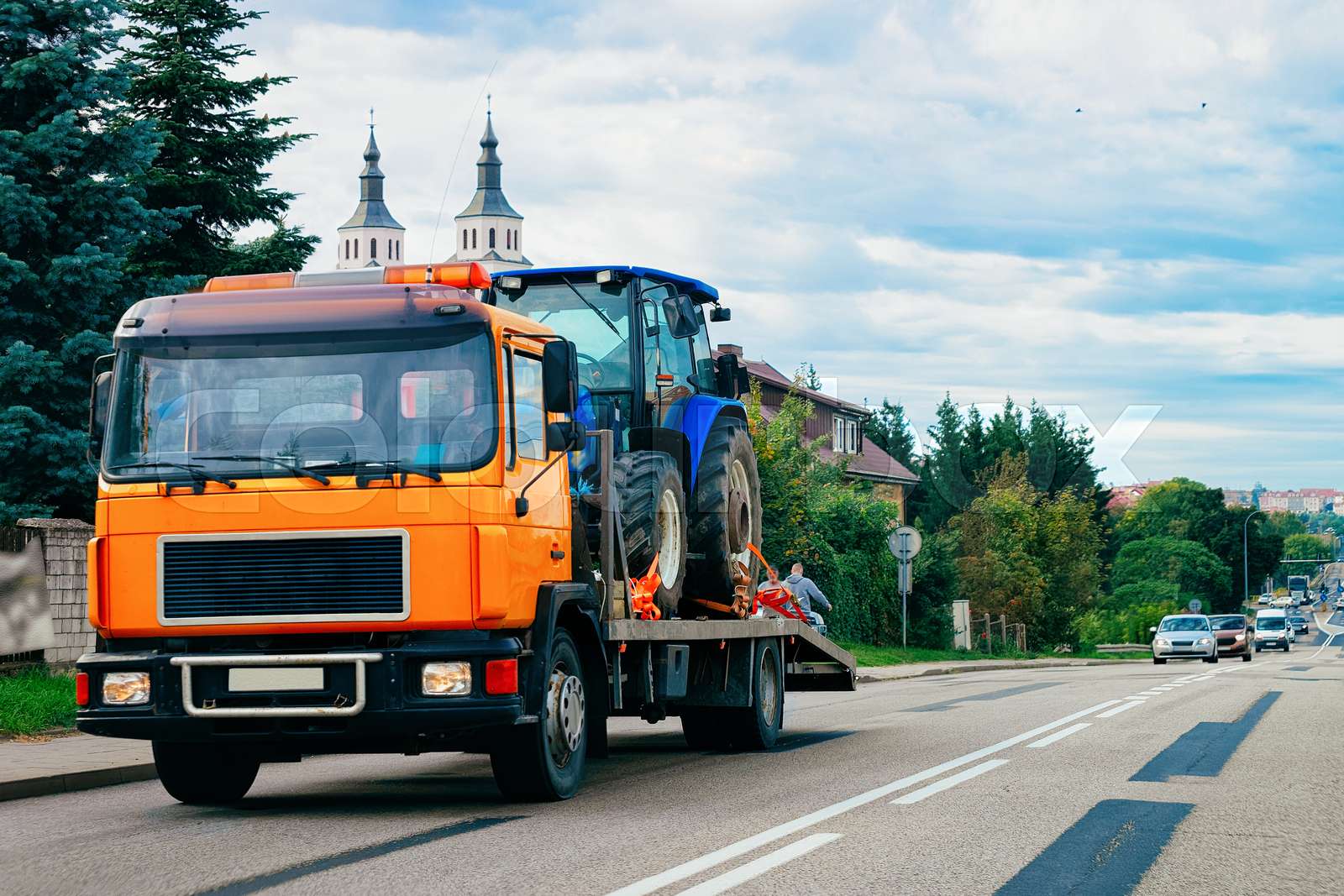Truck trailer transporter with hauler carrying tractor on road Poland ...