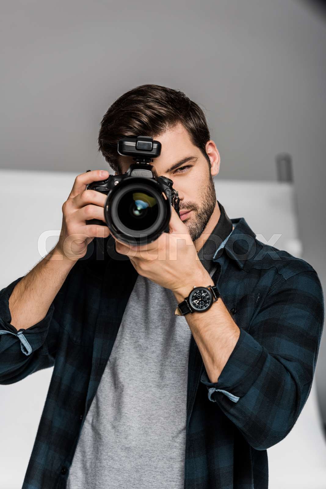 handsome young male photographer shooting with professional camera ...