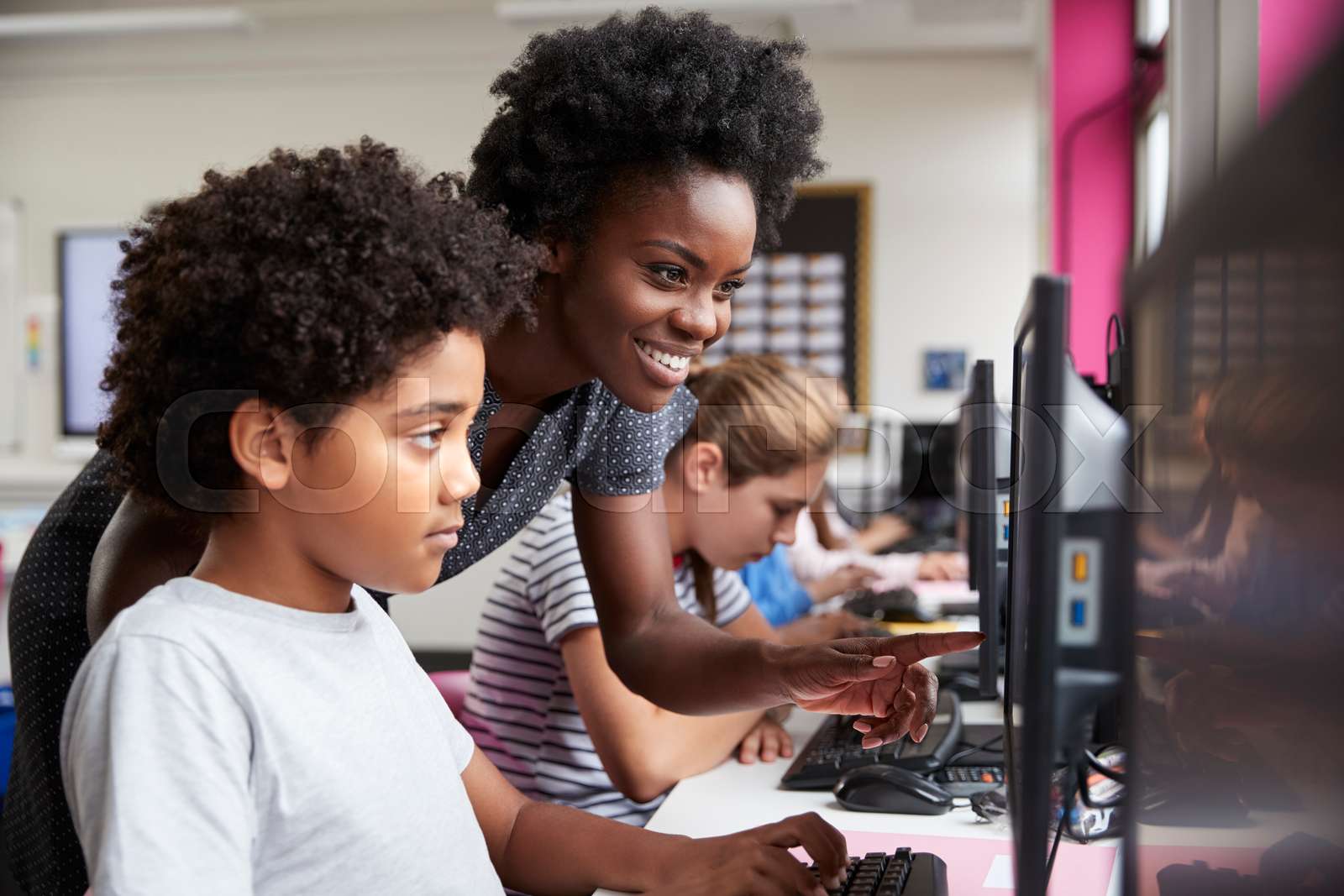 Teacher Helping Male Pupil Line Of High School Students Working at ...