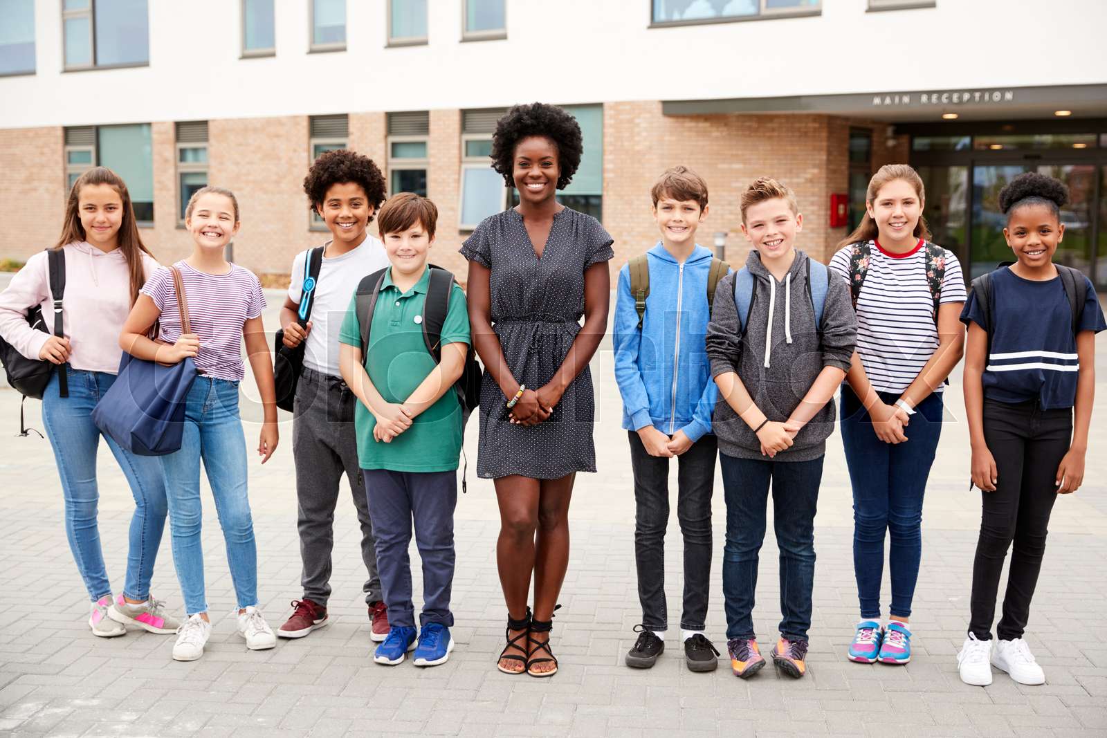 Portrait Of Smiling High School Student Group With Female Teacher ...