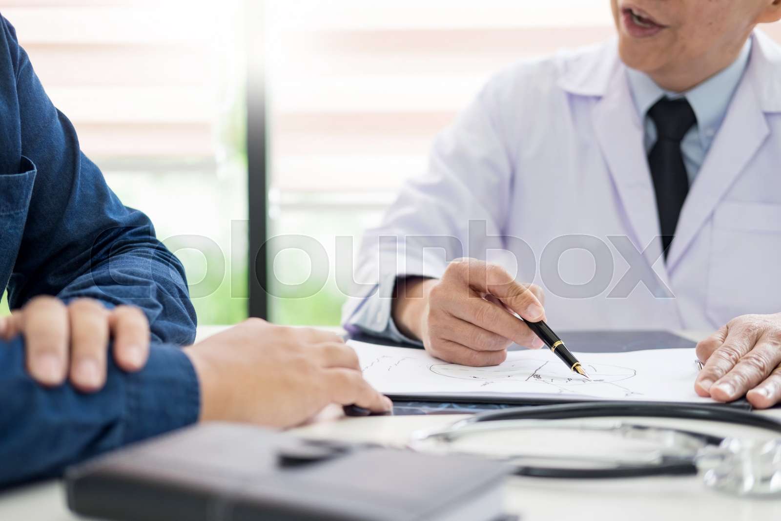 doctor giving a consultation discussing to patient and explaining ...