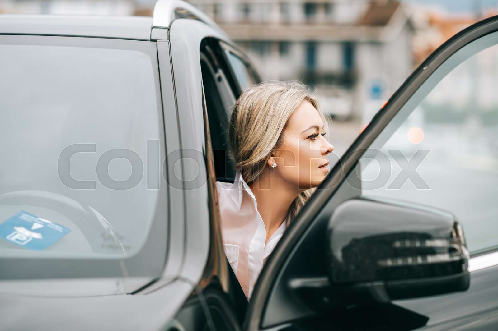 Beautiful woman coming out of the car | Stock image | Colourbox