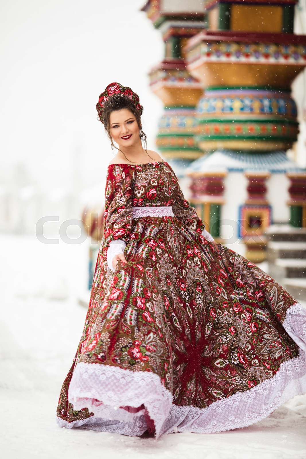 Beautiful happy woman is wearing traditional russian costume in winter ...