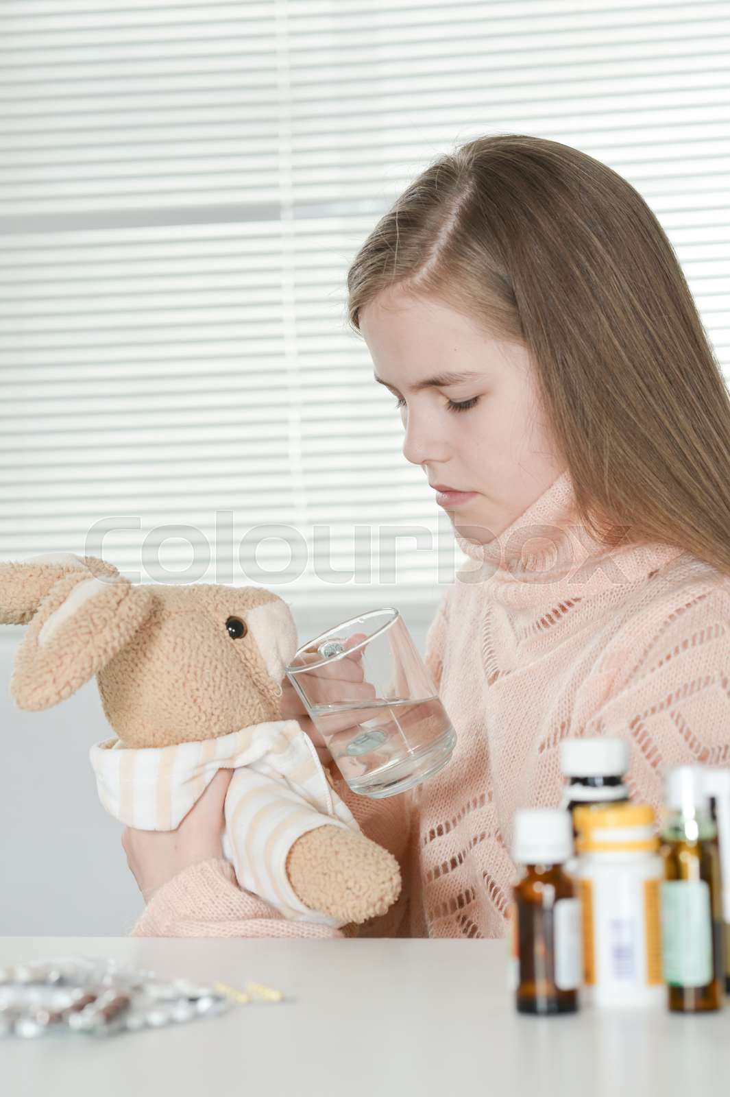 Close-up portrait of cute little girl taking medicine | Stock image ...