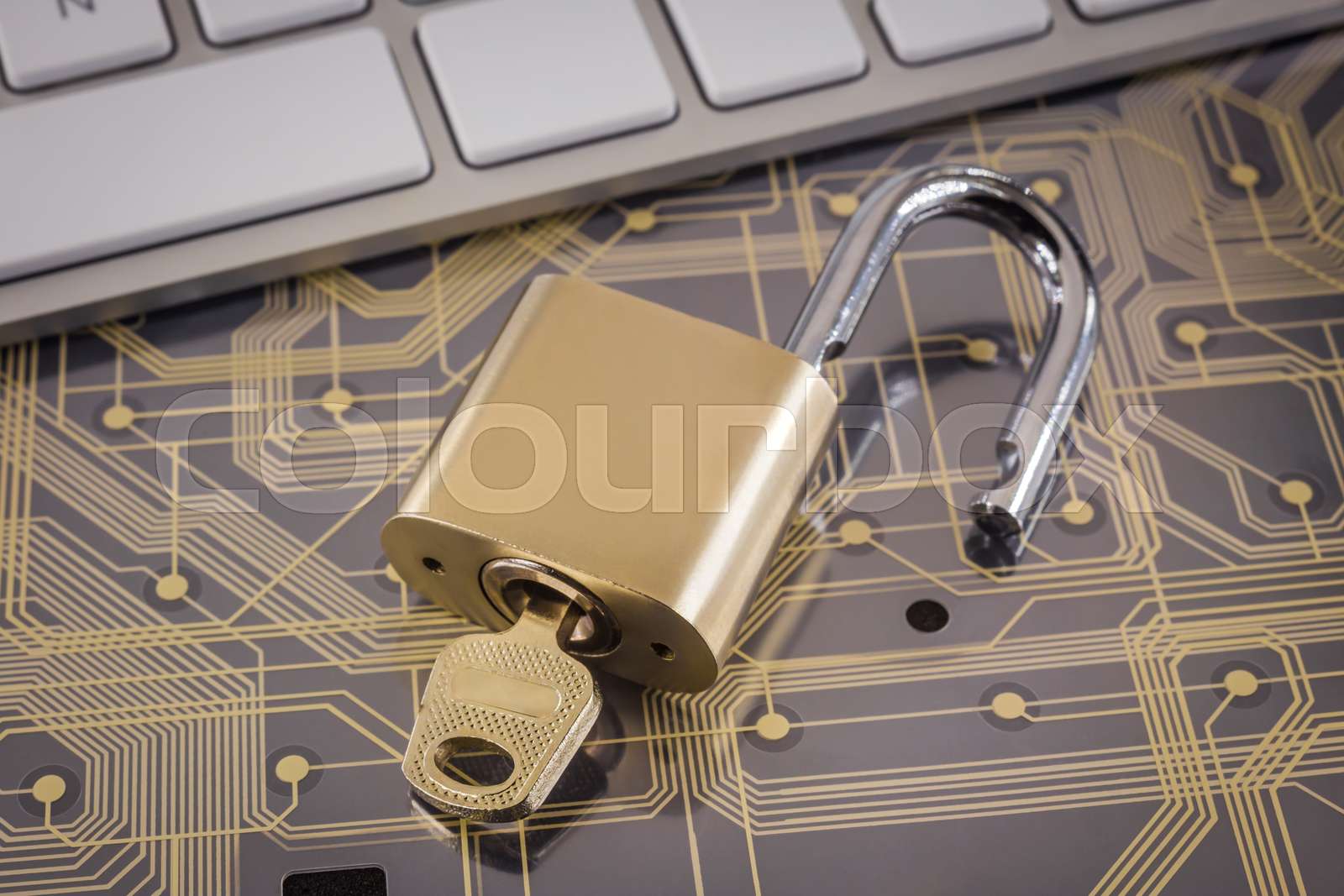 Cyber security with unlock key on circuit board. | Stock image | Colourbox