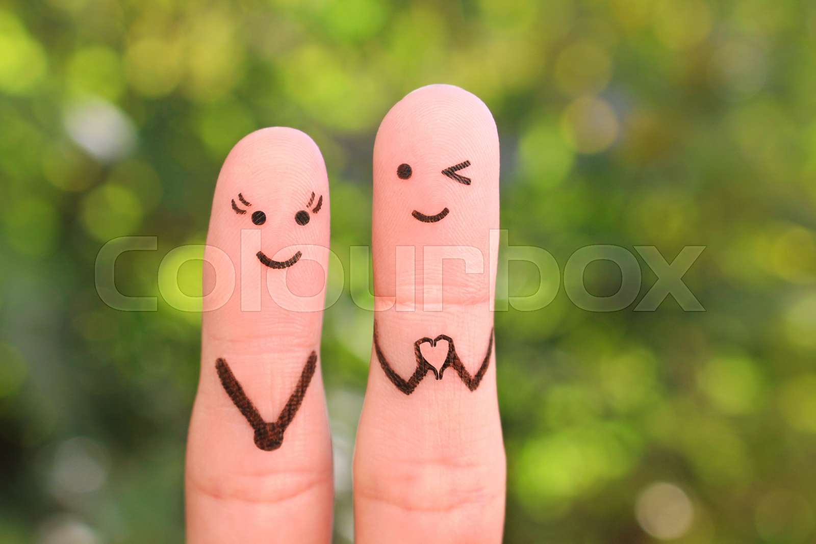 Fingers art of happy couple. Boyfriend showing fingers in heart shape ...