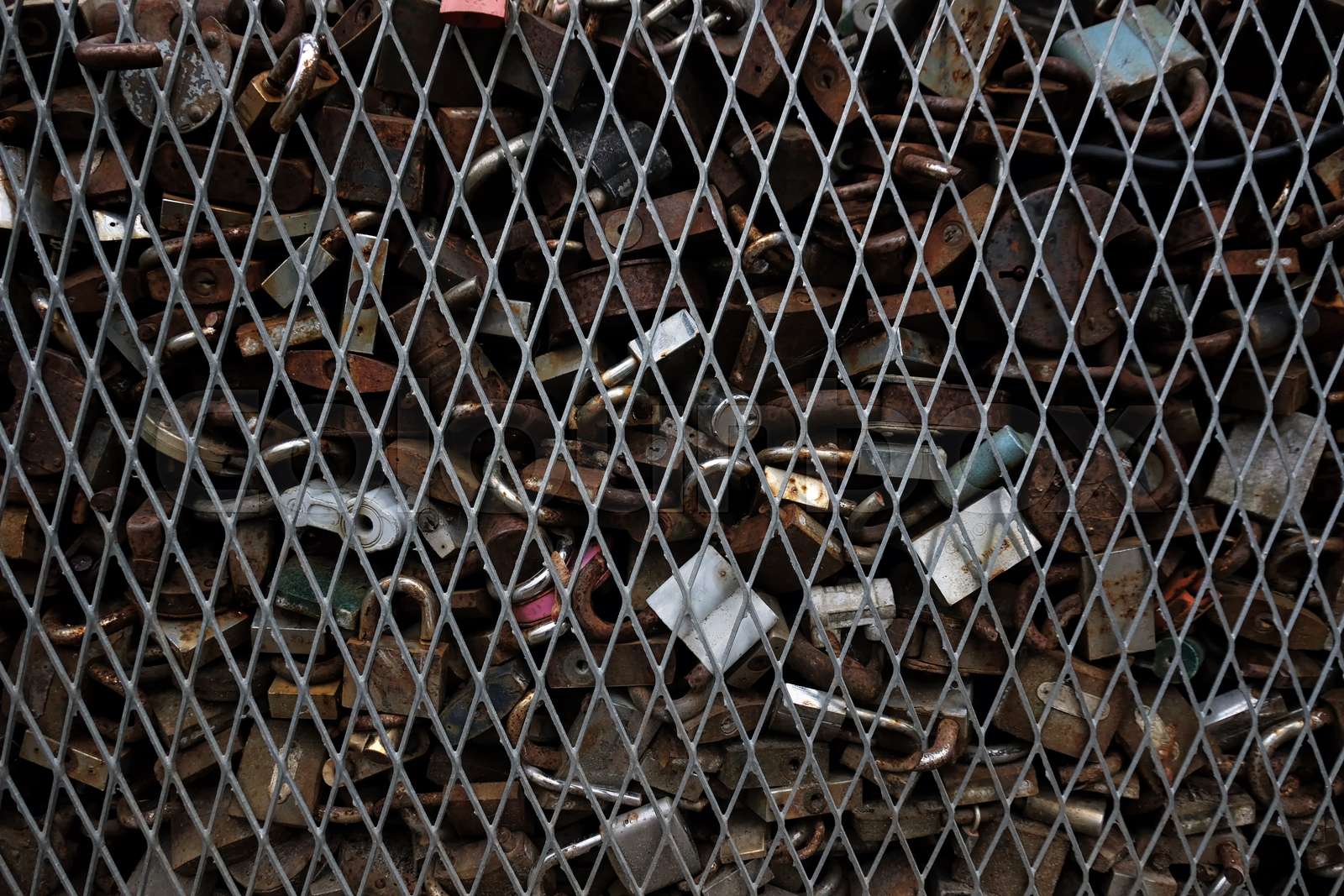 a lot of locks behind the fence | Stock image | Colourbox