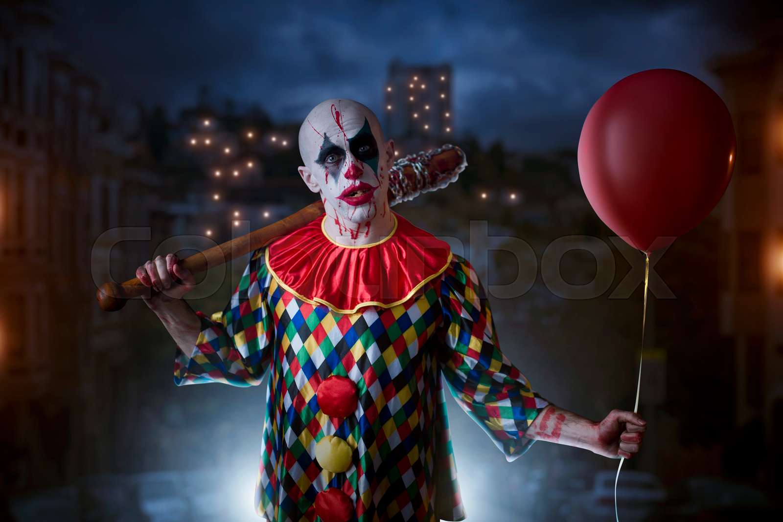 Scary bloody clown with baseball bat and balloon | Stock image | Colourbox
