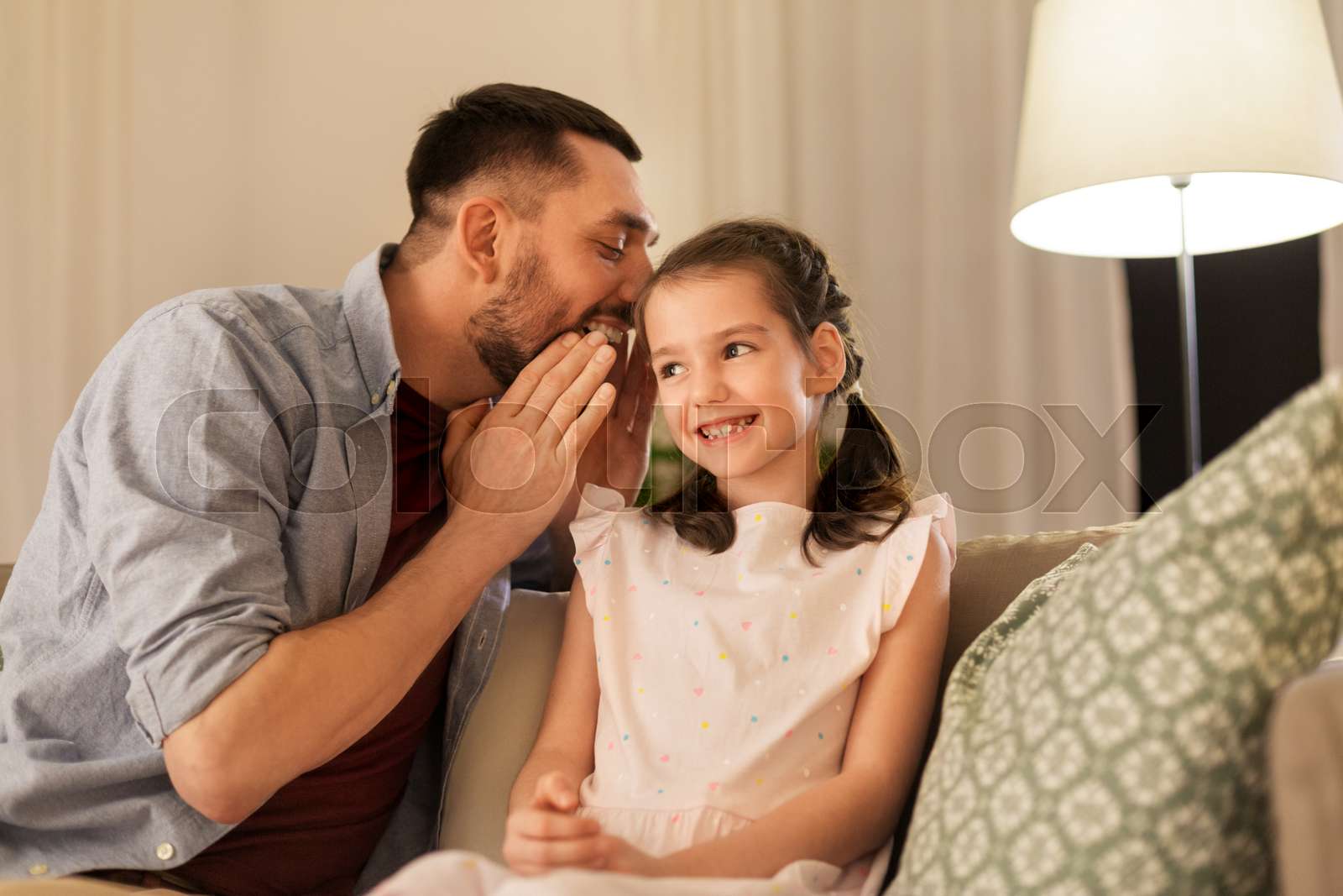 happy father whispering secret to daughter at home | Stock image ...