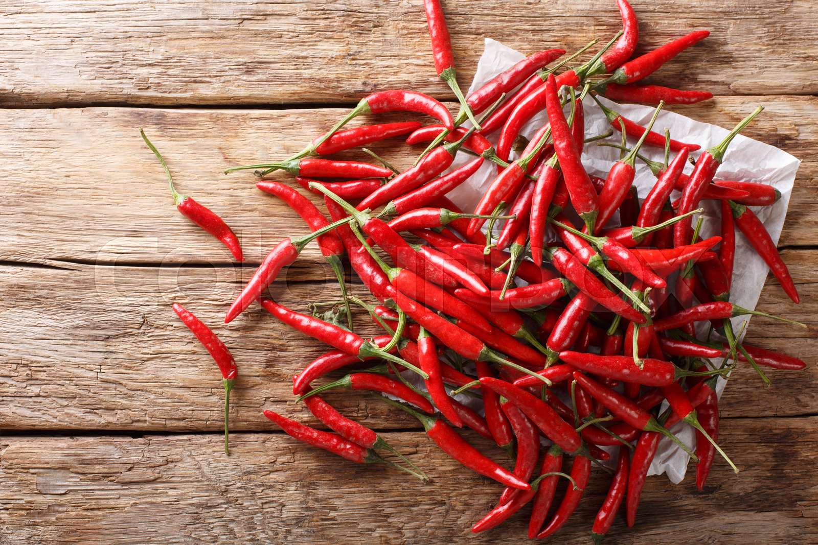 Crop of fresh hot chili piri-piri close-up on wooden. horizontal top ...