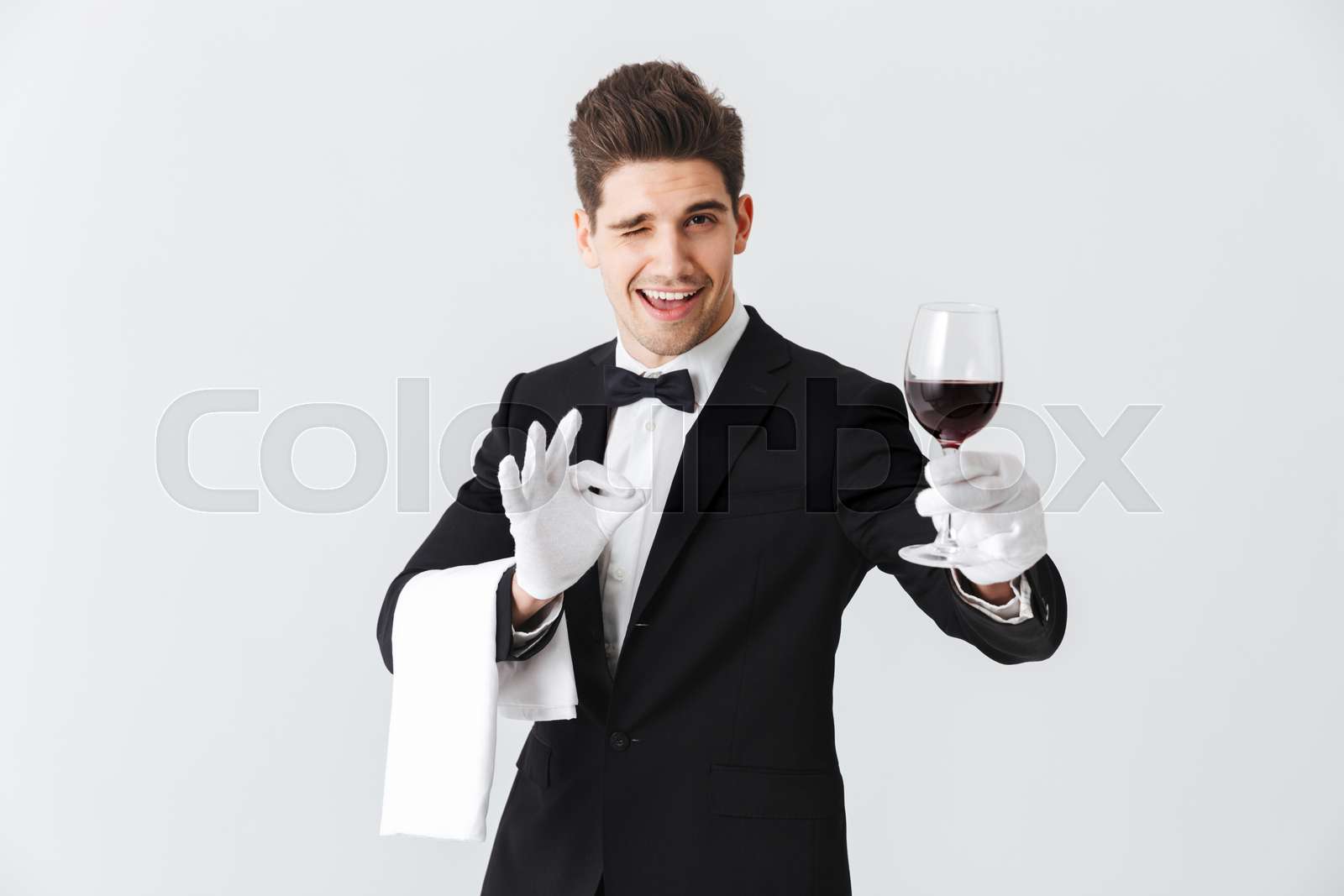 Handsome young waiter wearing tuxedo | Stock image | Colourbox