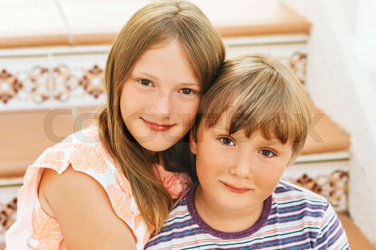 Outdoor summer portrait of two funny kids, small brother and big sister ...