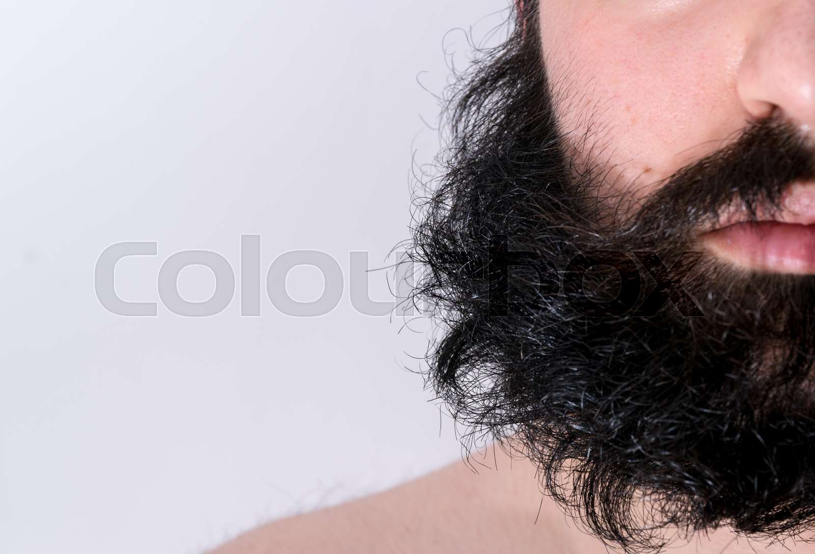 A part of a long ungroomed beard with long, messy and untrimmed hair ...
