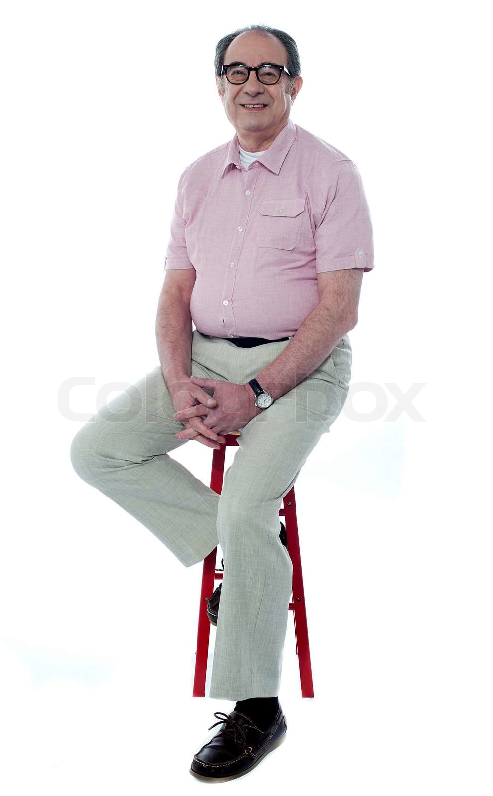 Confident senior man resting on stool | Stock image | Colourbox