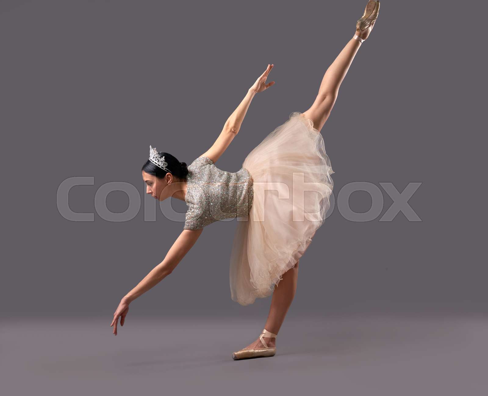Ballerina bending down and raising one leg up in studio | Stock image ...