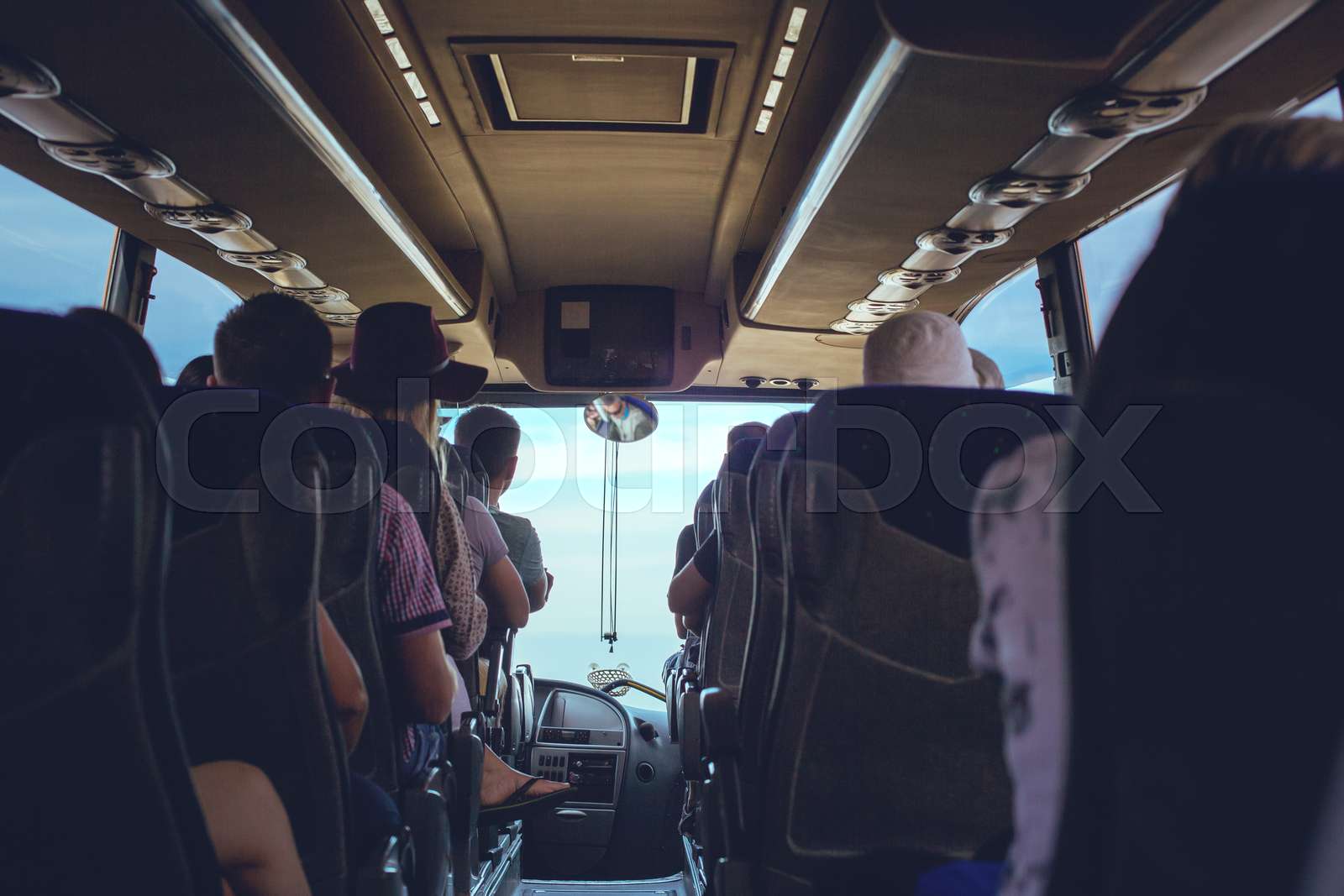 The tourist bus interior with people sitting | Stock image | Colourbox