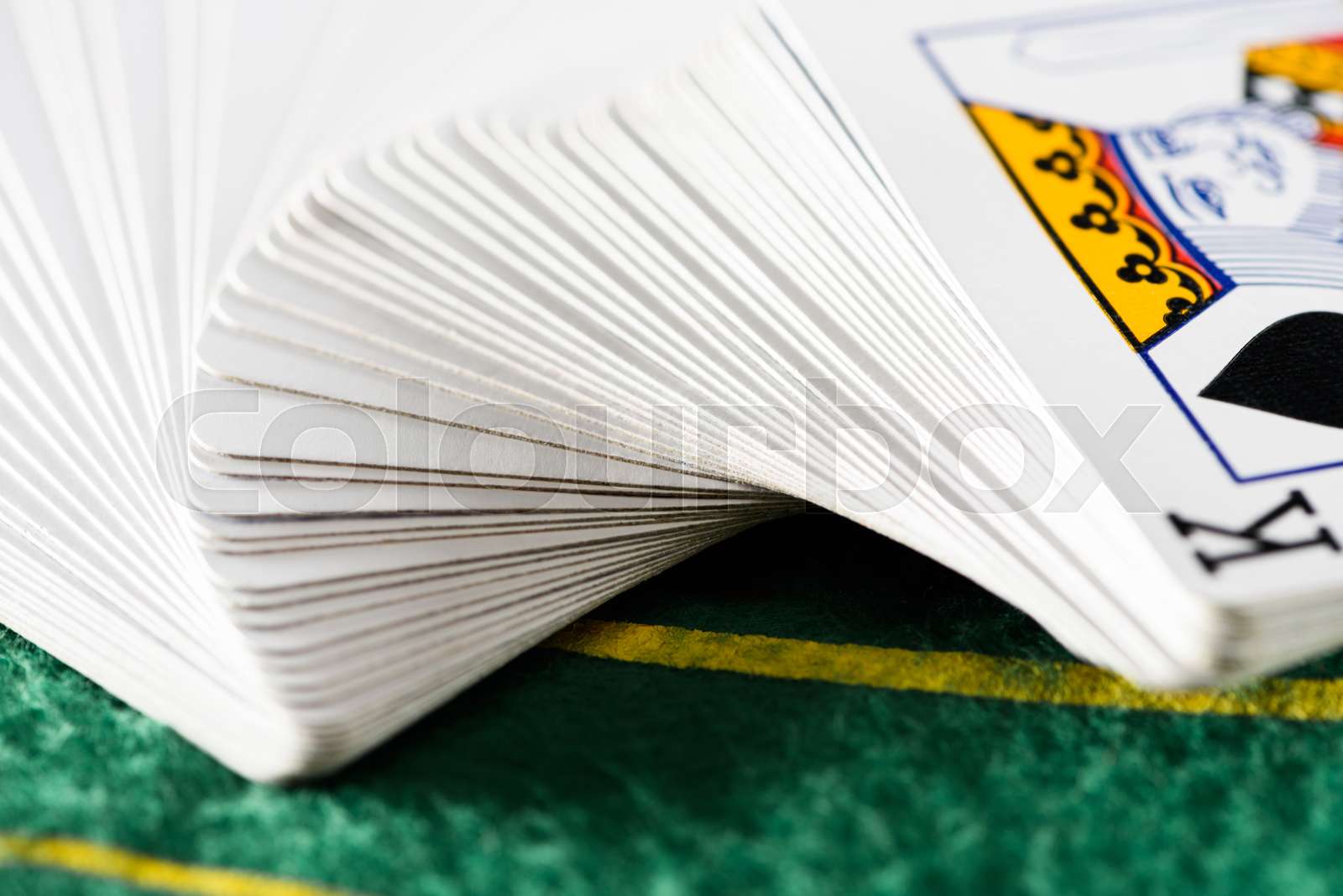 selective focus of horizontally spread out playing cards in deck on ...
