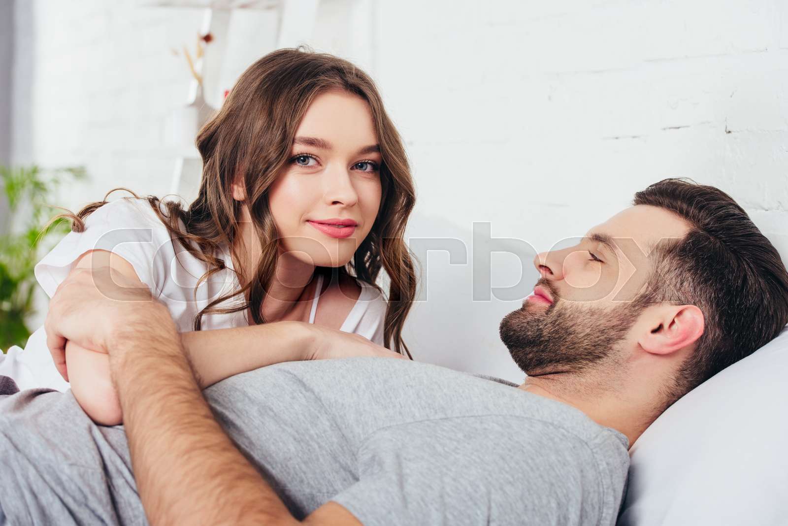 selective focus of young loving couple gentle hugging in bed | Stock ...