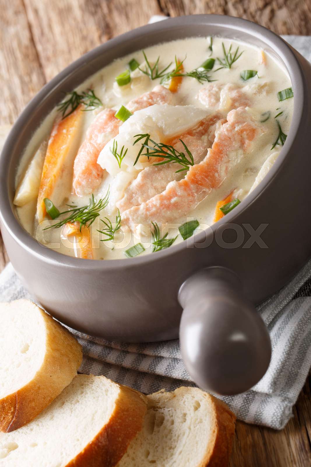 Closeup of Norwegian fiskesuppe creamy fish soup with cod and salmon ...