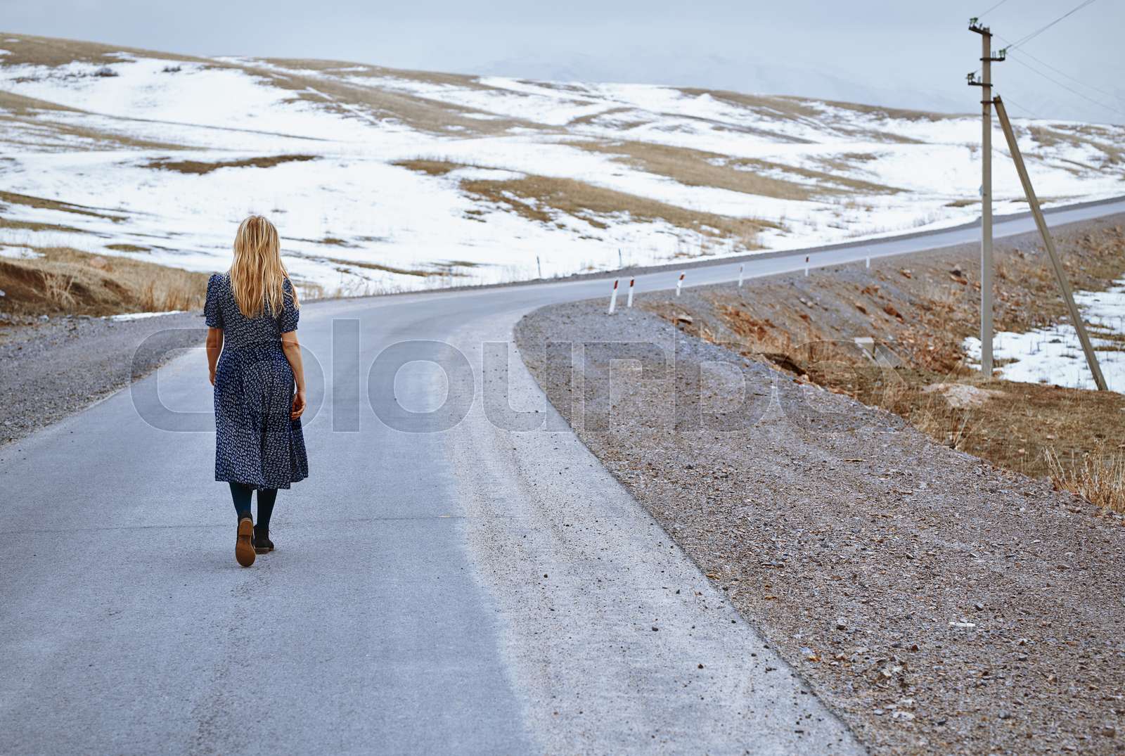 Woman walking along the rural highway | Stock image | Colourbox