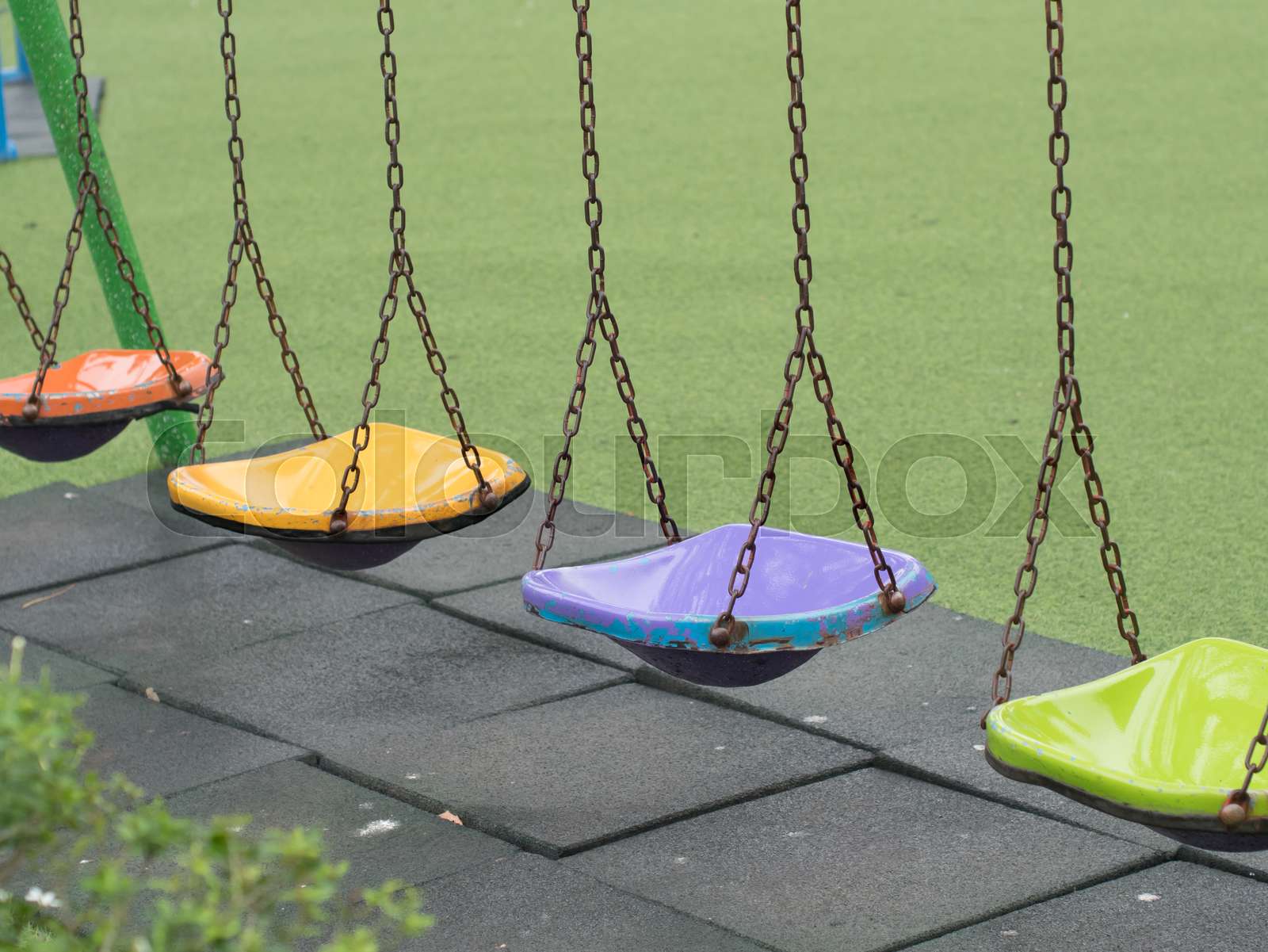 Empty chain swing in playground. | Stock image | Colourbox