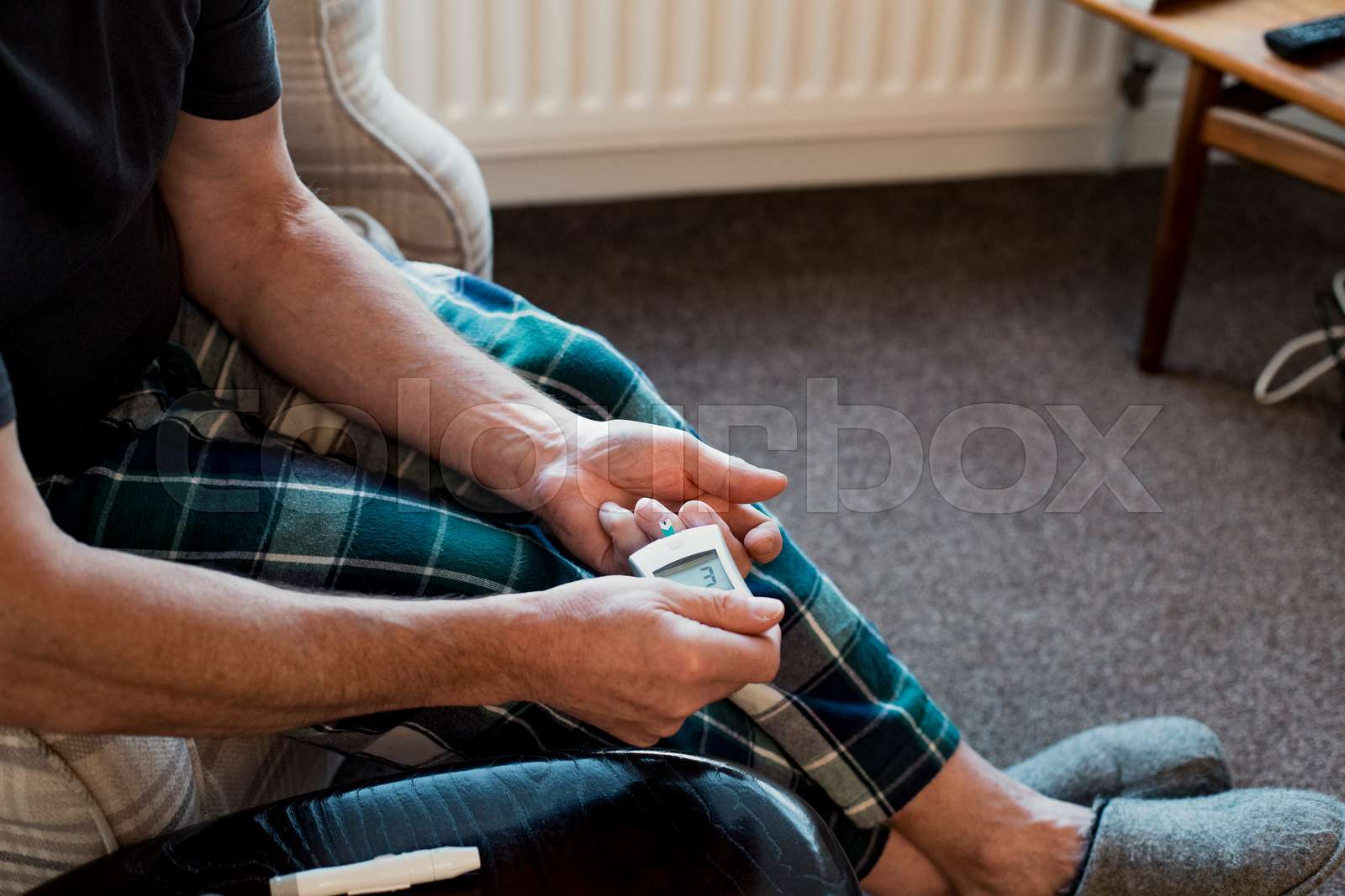 Diabetic Man Checking Glucose Levels | Stock image | Colourbox