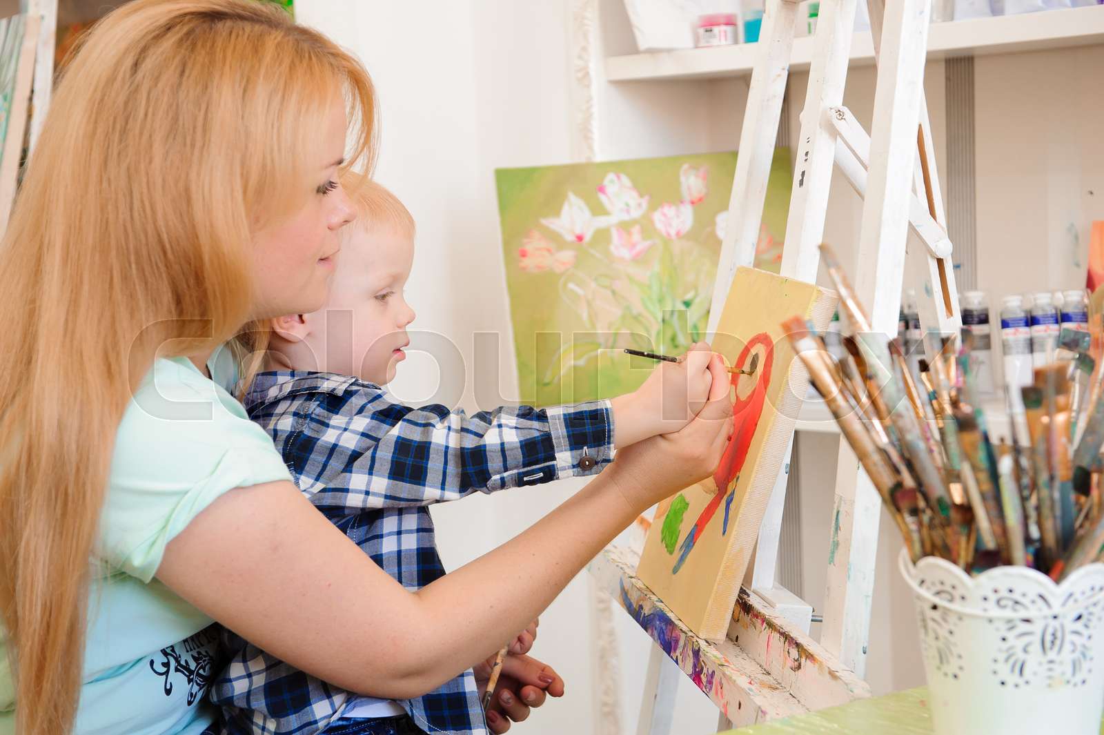 Mother and child draw a picture paints, art lesson | Stock image | Colourbox